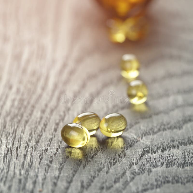 Fish Oil Capsules with Bottle on Wooden Table Stock Photo - Image of ...