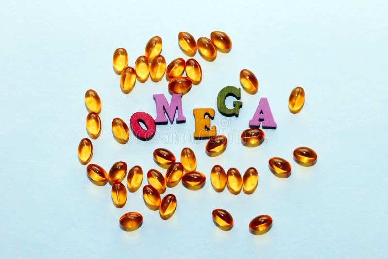Fish Oil Tablets in a Golden Jelly Shell with the Letters Omega on a ...