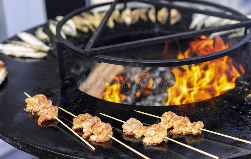 Fish and Other Seafood are Fried on a Round Grill Stock Image - Image ...