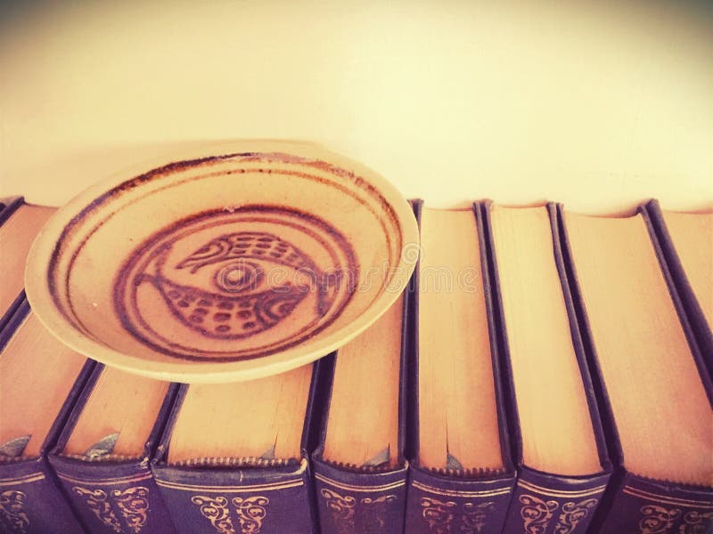 Fish plate on books stock image. Image of plate, ceramic - 67778359