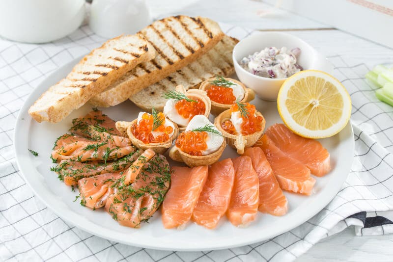 Fish Plate with Different Types of Smoked and Salted Fish, Lemon and ...