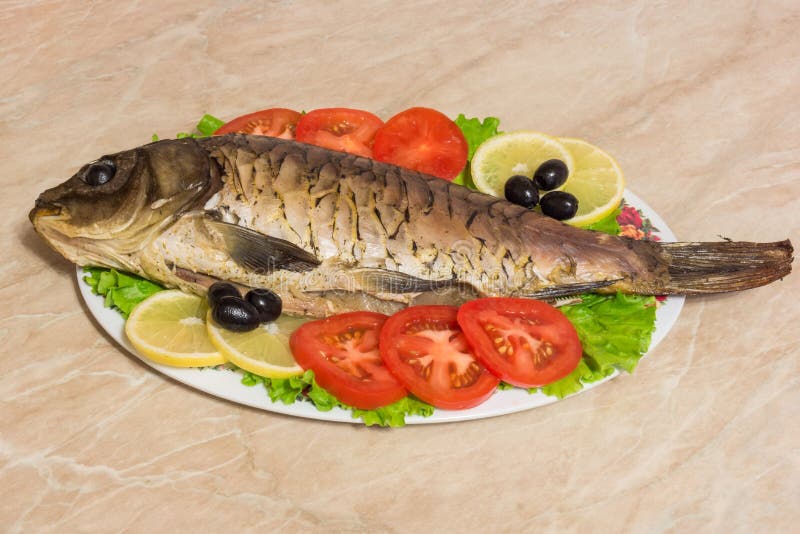 Fish on a plate stock image. Image of fish, bones, olives - 61231649
