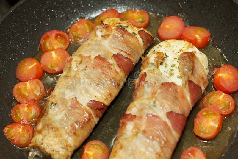 Fish Rolled in Ham with Tomatoes Stock Photo - Image of frying ...