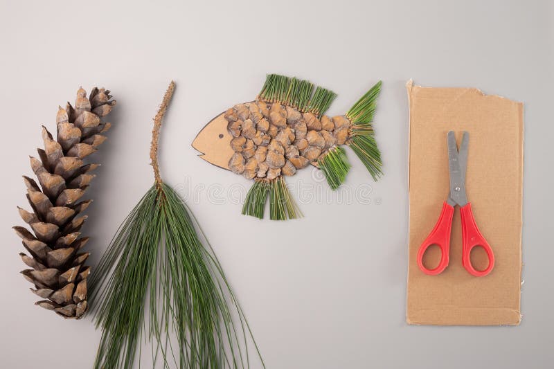 Fish Shaped Craft Made of Pine Cones and Pine Needles with Red Scissors ...