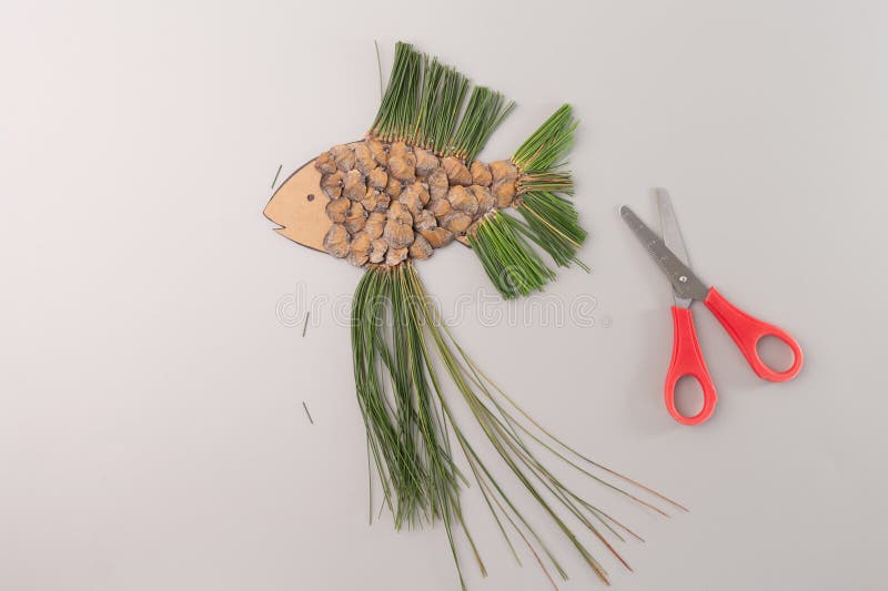Fish Shaped Craft Made of Pine Cones and Pine Needles with Red Scissors ...