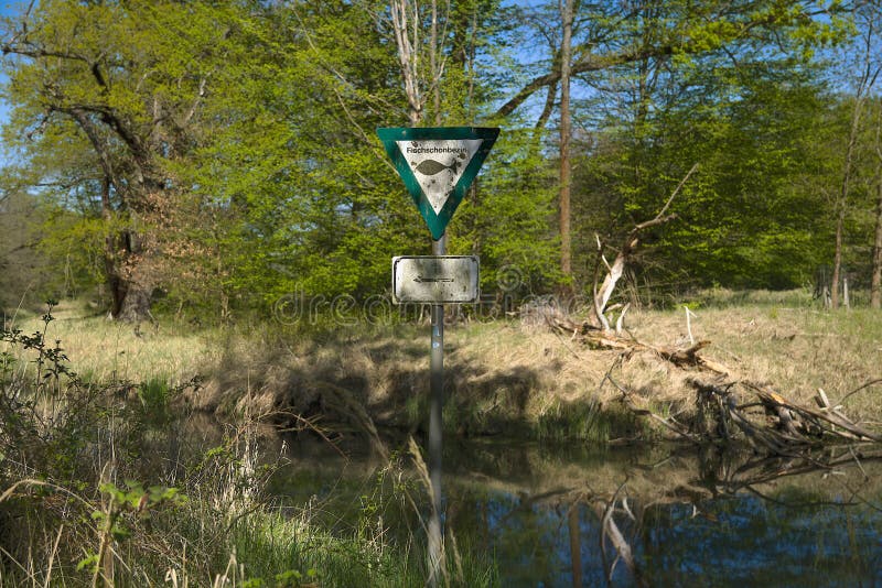 A Fish-shaped Sign Next To a River. Stock Image - Image of sign, symbol ...