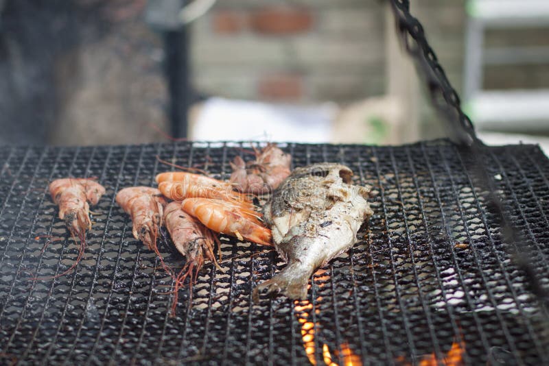 Fish and Shrimp Cooked on the Grill Above the Fire Stock Photo - Image ...