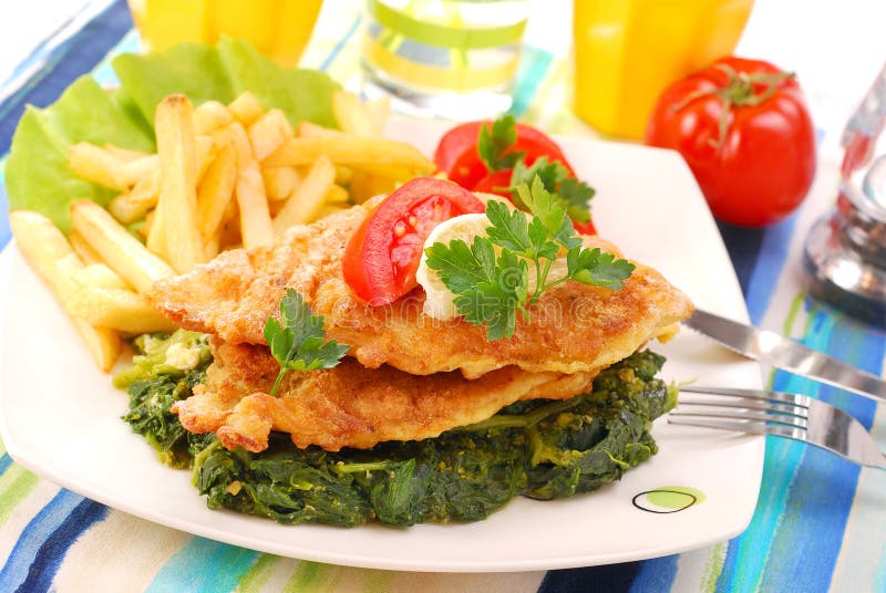 Fish on spinach with fries stock image. Image of diet - 14395473