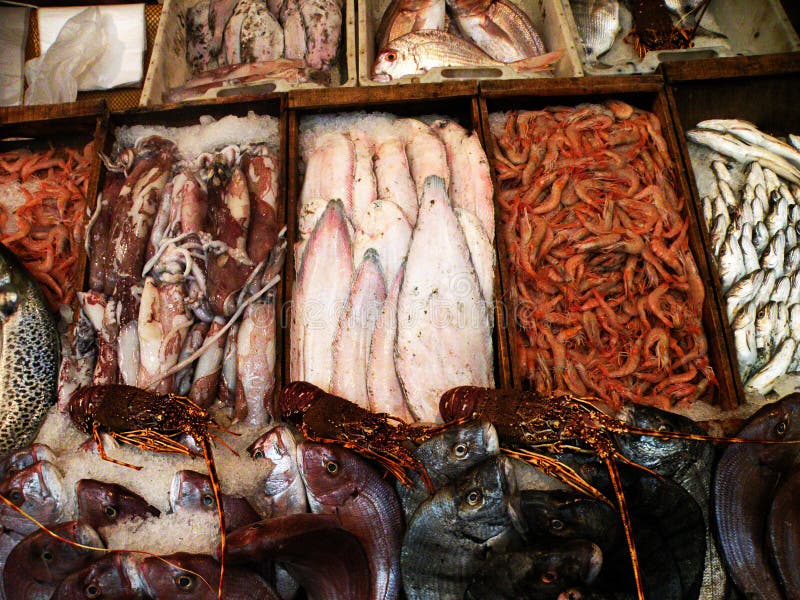 Trade Seafood, A Man Weighs Fish On The Scales Of A Street Vendor Stock ...