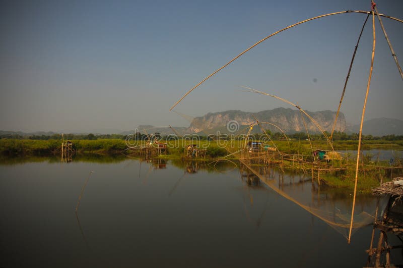 Fish traps stock image. Image of tree, waterway, dawn - 370722301