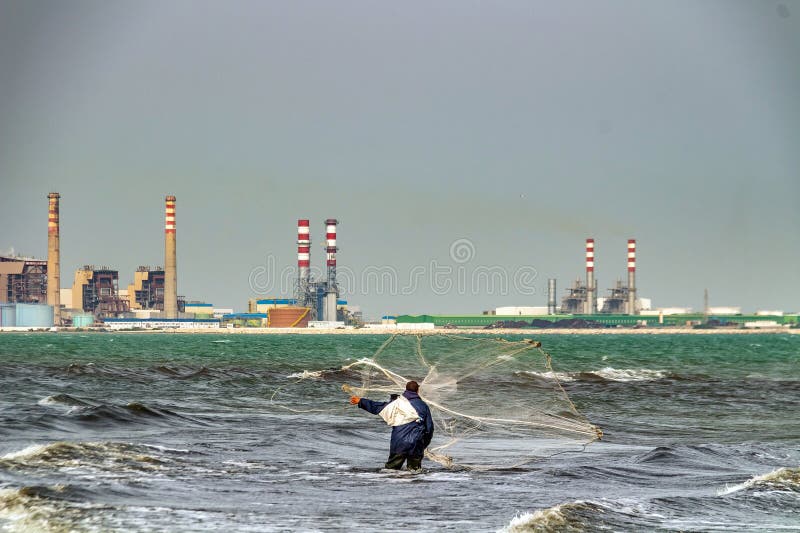A Fisherman Casting His Nets into the Sea Stock Photo - Image of ...