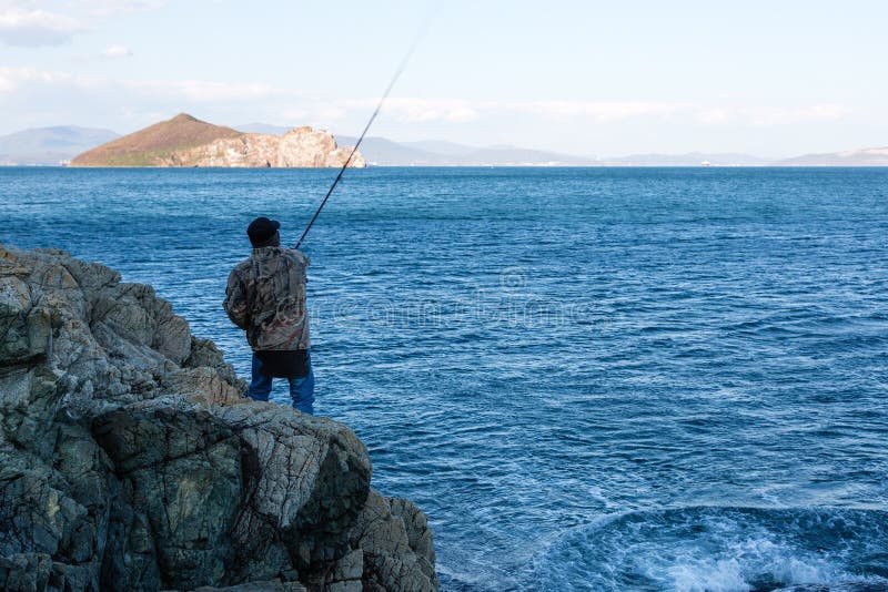 Fisherman Catches Fish on the Sea Stock Photo - Image of fishing ...