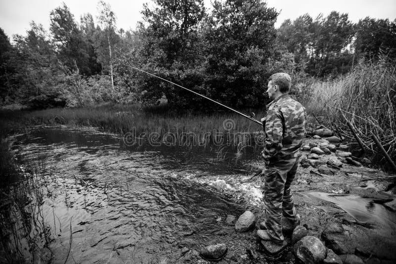 Fisherman Catching Fish on the Lake. Black and White Photo. Stock Image ...