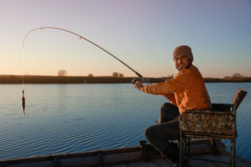 Fisherman Catching Fish with Rod at Riverside Stock Photo - Image of ...