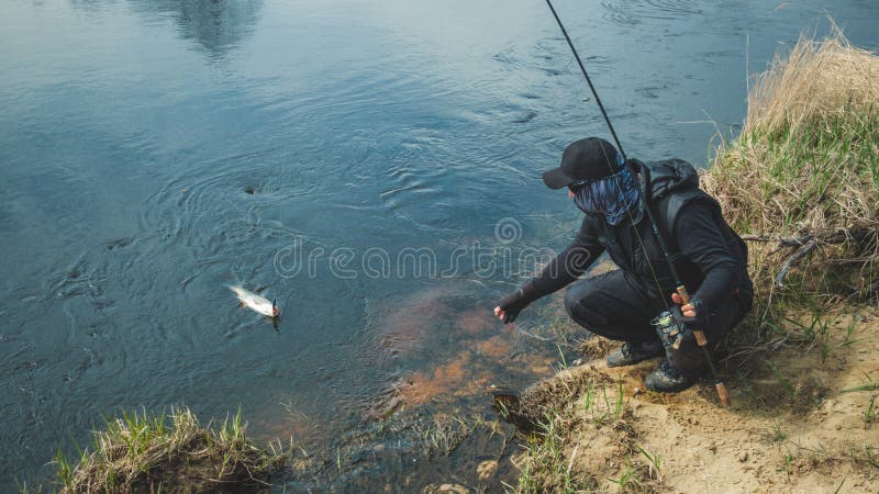 Fisherman Caught a Fish on the River Bank Stock Image - Image of ...
