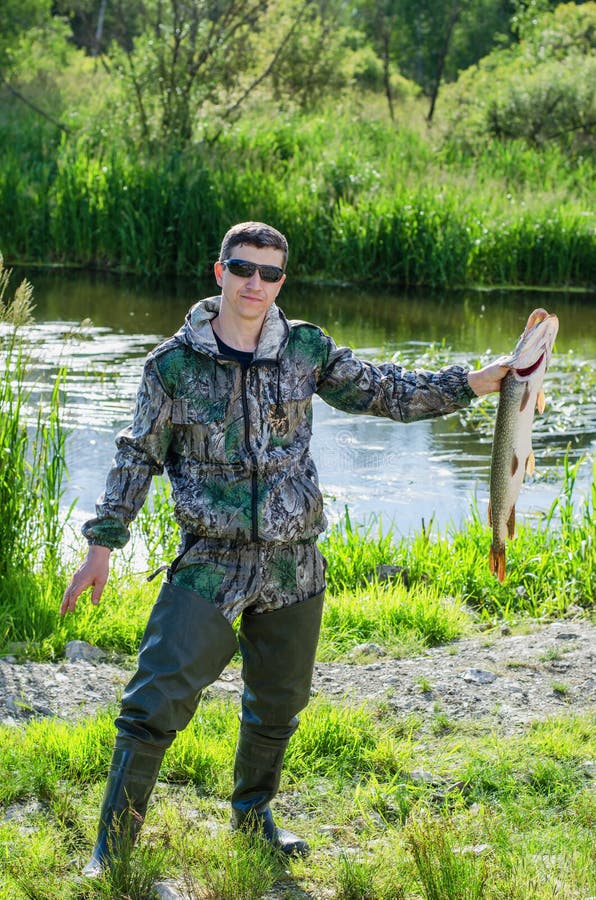 The Fisherman with the Caught Pike Stock Image - Image of large ...