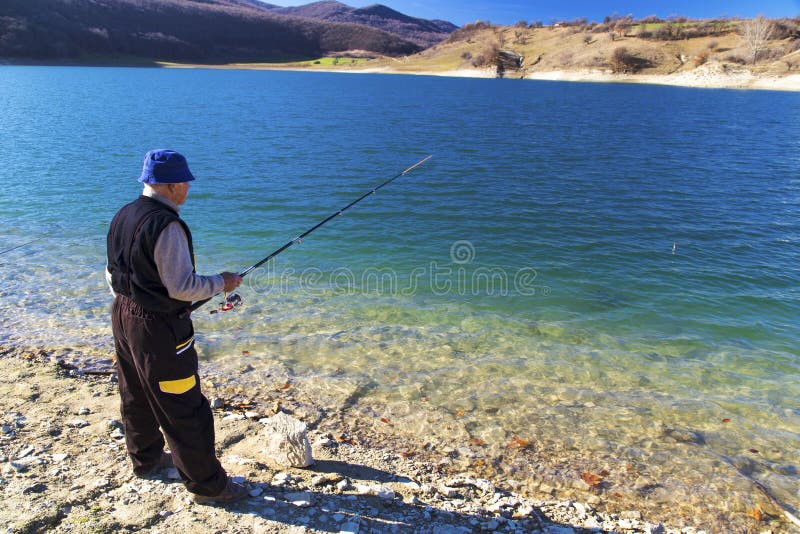 Fisherman Fishing on Blue Lake Stock Photo - Image of dawn, hobby: 65253616