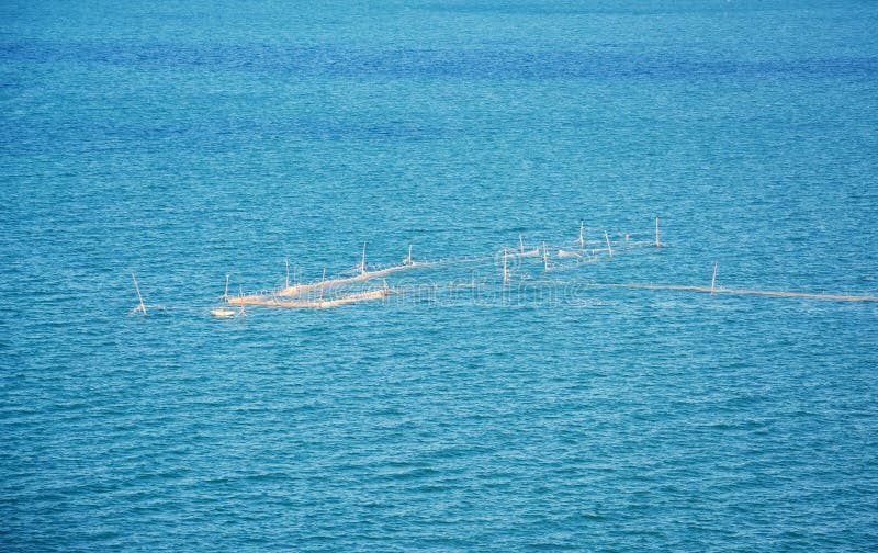 A Fisherman on a Fishing Boat is Casting a Net for Catching Fish Stock ...