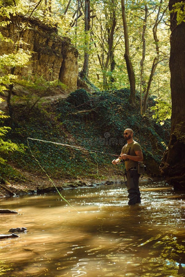 A Fisherman Fishing with Fly Fishing Stock Image - Image of spinning ...