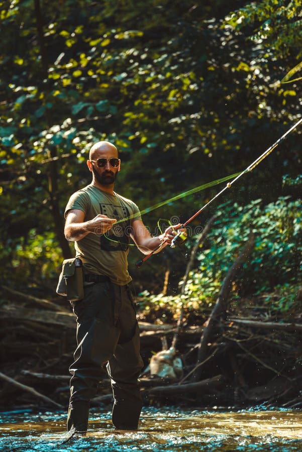 A Fisherman Fishing in the Flowing Stream Stock Photo - Image of ...