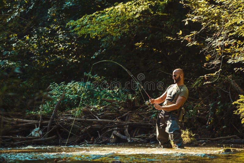 A Fisherman Fishing in the Flowing Stream Stock Photo - Image of river ...
