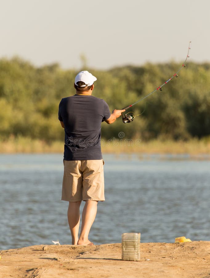Fisherman with a Fishing Rod on the River Stock Photo - Image of person ...