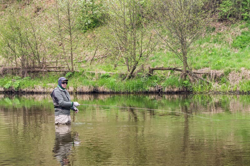 Fisherman Fishing on a Small Spring River. Fly Fishing Stock Photo ...