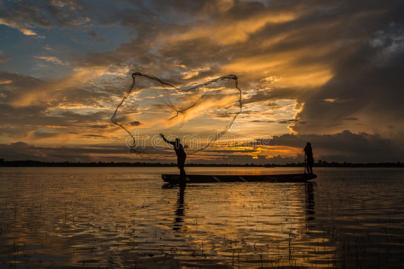 Fisherman is Fishing by Using Fishing Net on the River. Stock Photo ...