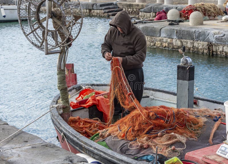 Fisherman fixing his nets editorial image. Image of boat - 88034080