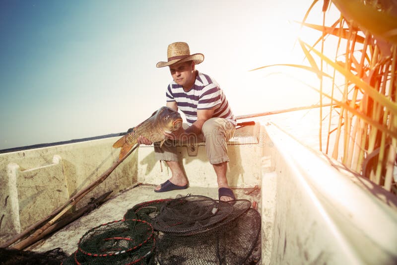 Fisherman Holding a Big Fish Stock Photo - Image of travel, mirror ...