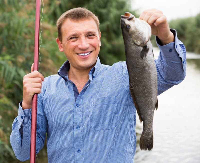 Fisherman Holding Catch Fish in Hands Outdoors Stock Image - Image of ...