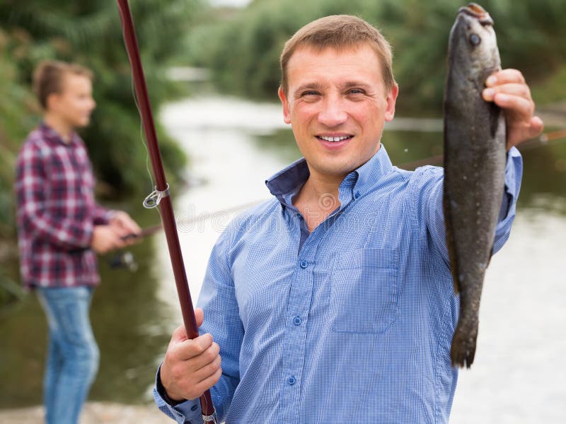 Fisherman Holding Catch Freshwater Fish in Hands Stock Photo - Image of ...