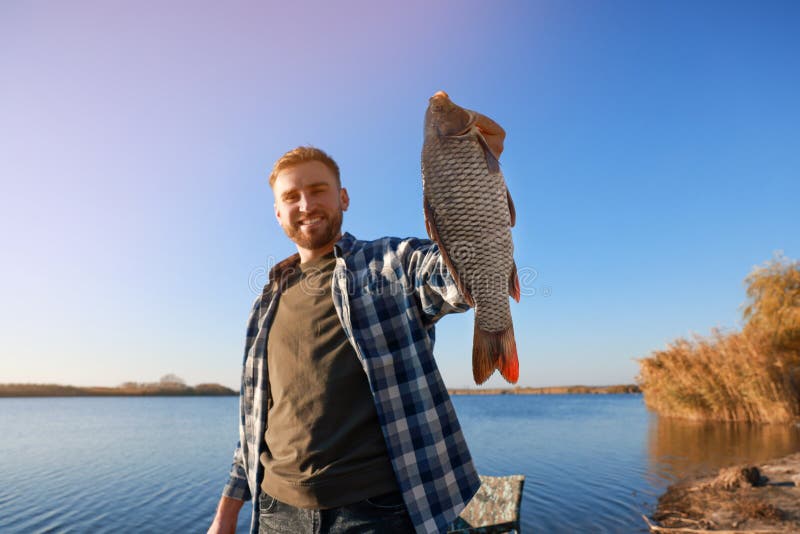 Fisherman Holding Caught Fish at Riverside. Recreational Activity Stock ...