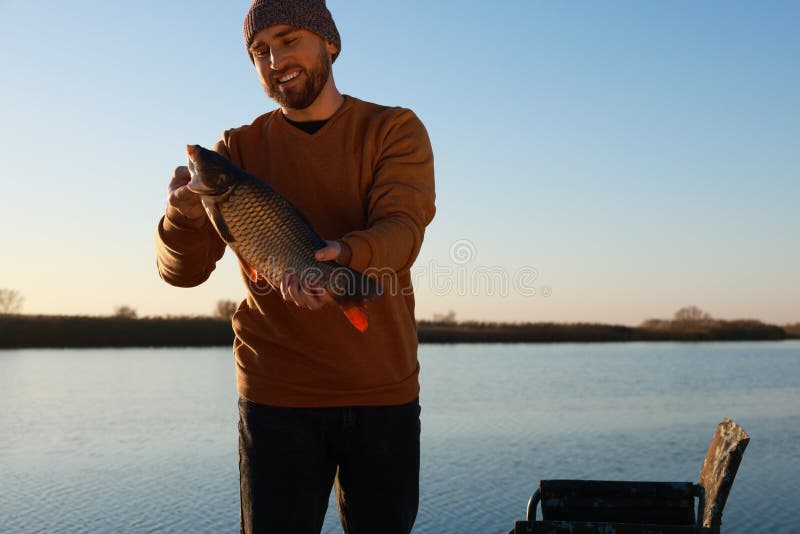 Fisherman Holding Caught Fish at Riverside. Recreational Activity Stock ...