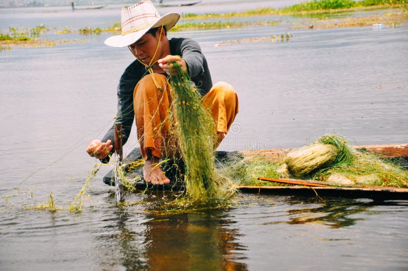 A Fisherman Holding a Net at Inle Lake. Editorial Stock Image - Image ...