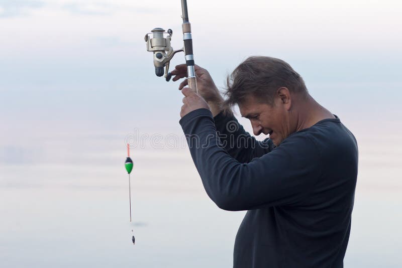 Fisherman Pulls a Fish with a Spinning Rod Stock Photo - Image of spin ...