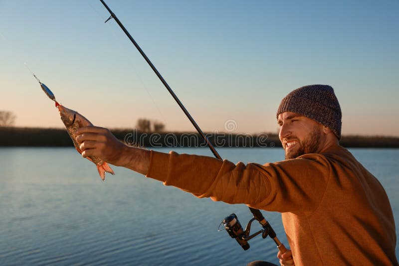 Fisherman with Rod and Caught Fish at Riverside Stock Image - Image of ...