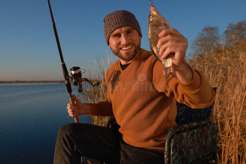 Fisherman with Rod and Caught Fish at Riverside Stock Image - Image of ...
