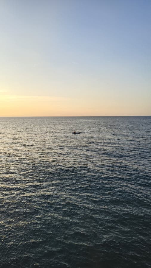A Fisherman Rowing His Boat Stock Photo - Image of fisherman, rowing ...