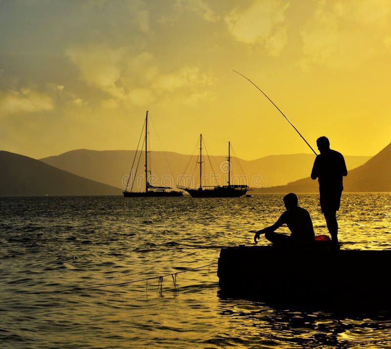 Fisherman in Silhouette on a Fresh Water Lake during Stunning Sunset ...