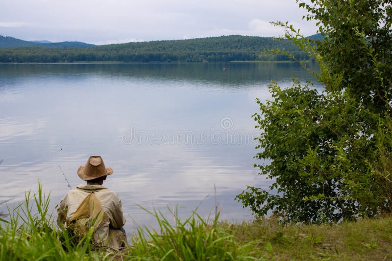 The Fisherman Sits by the Lake. Back View. Stock Photo - Image of ...
