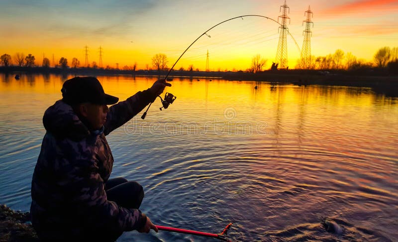 Fisherman at Sunset Who is Catching a Fish Stock Image - Image of light ...