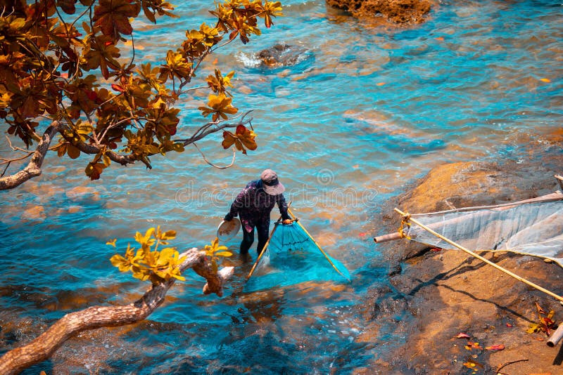 Fisherman Using Nets To Catch Fish on the Shore in the Philippines ...