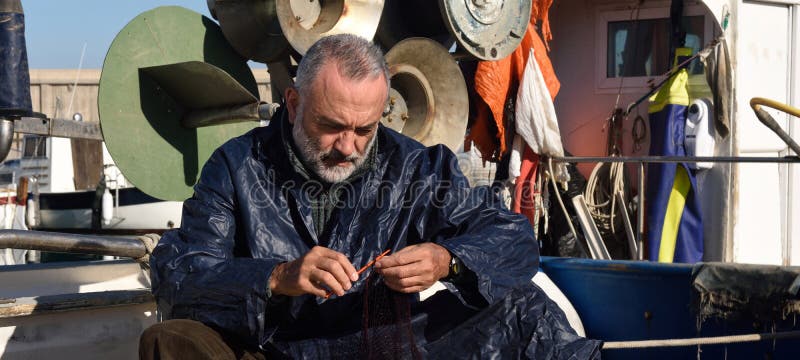 A Fisherman Working in the Sea Stock Photo - Image of fishing, tough ...