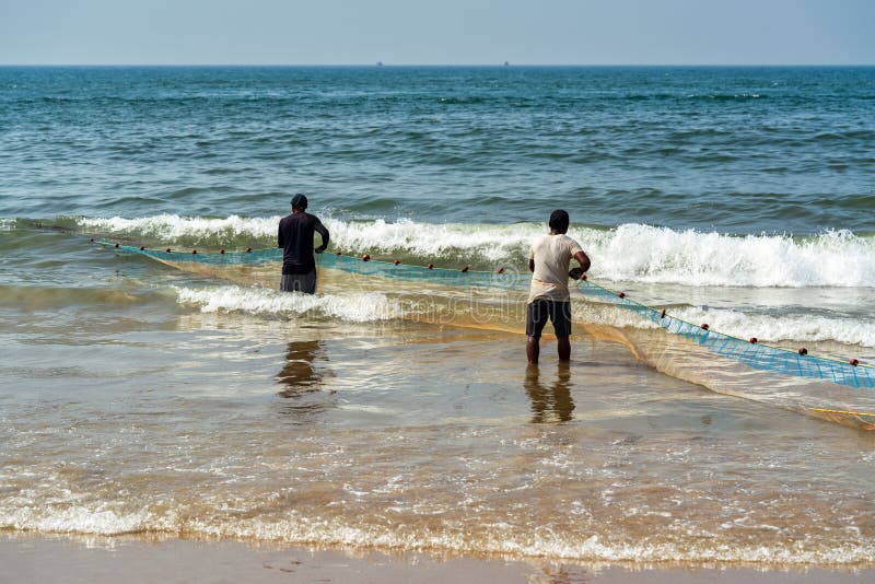 Fishermen Along with Tourists Pulling Nets with Fish from the Sea on ...