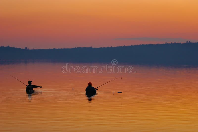 Fishermen in Cyprus Lake at Sunset Stock Photo - Image of beach ...