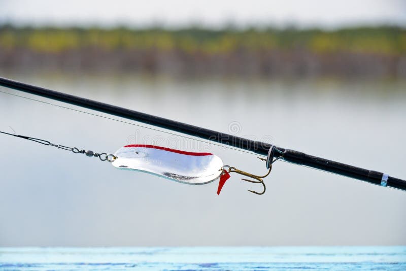 The Fishing Rod with a Bite Indicator on the Stand on the Lake Stock ...