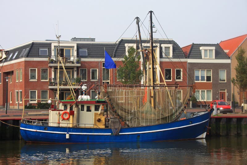 Fishing Vessels and on the Background Fish Auction in the Harbor of ...