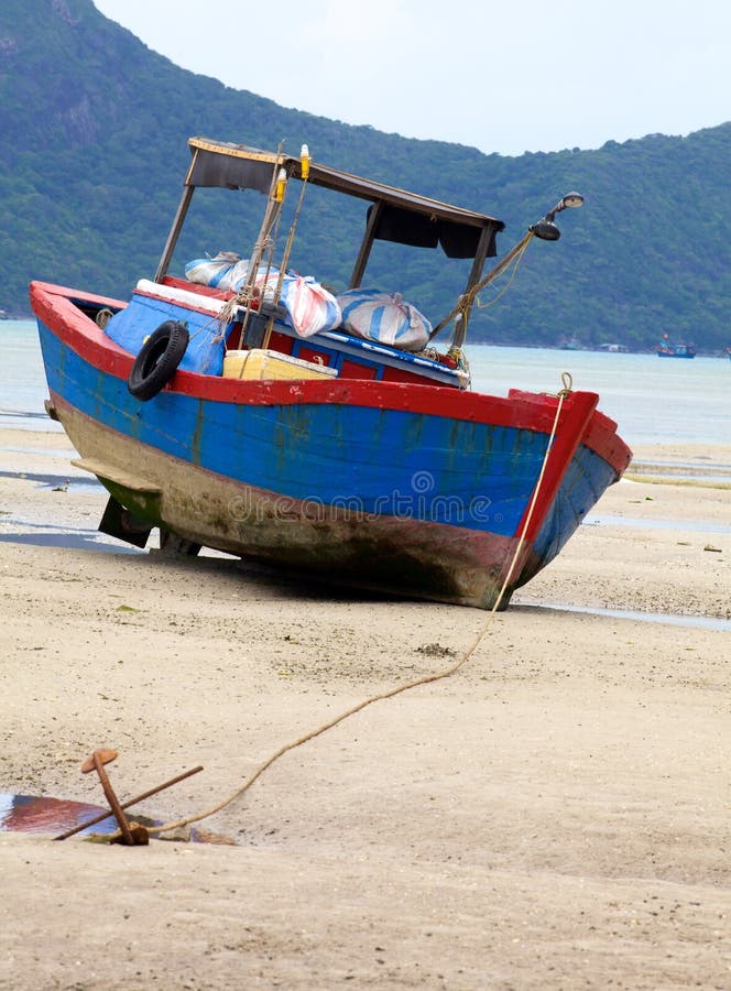 An Old Fishing Boat Moored Beached On The Beach At Low Tide. Stock ...
