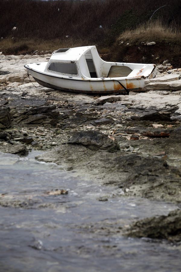 Fishing Boat Beached on a Rock Stock Image - Image of dusk, broken ...